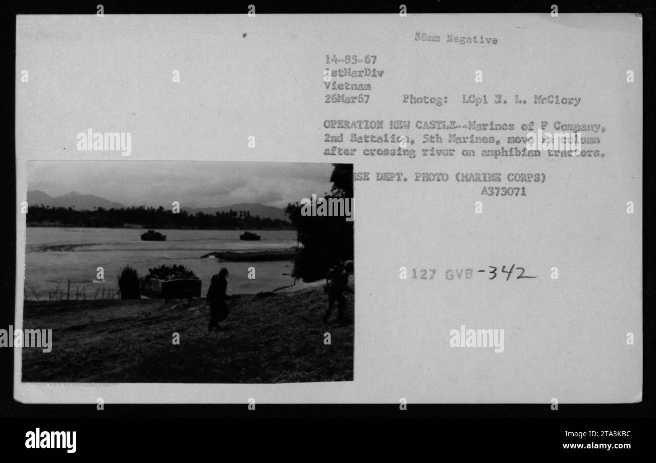 Marines of F Company, 2nd Battalion, 5th Marines, move in column ...