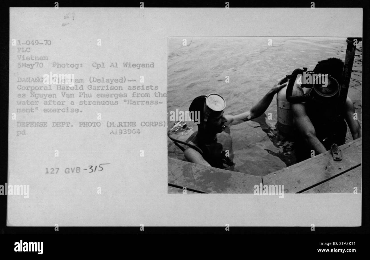 Corporal Harold Garrison assists Nguyen Van Phu during a harassment ...