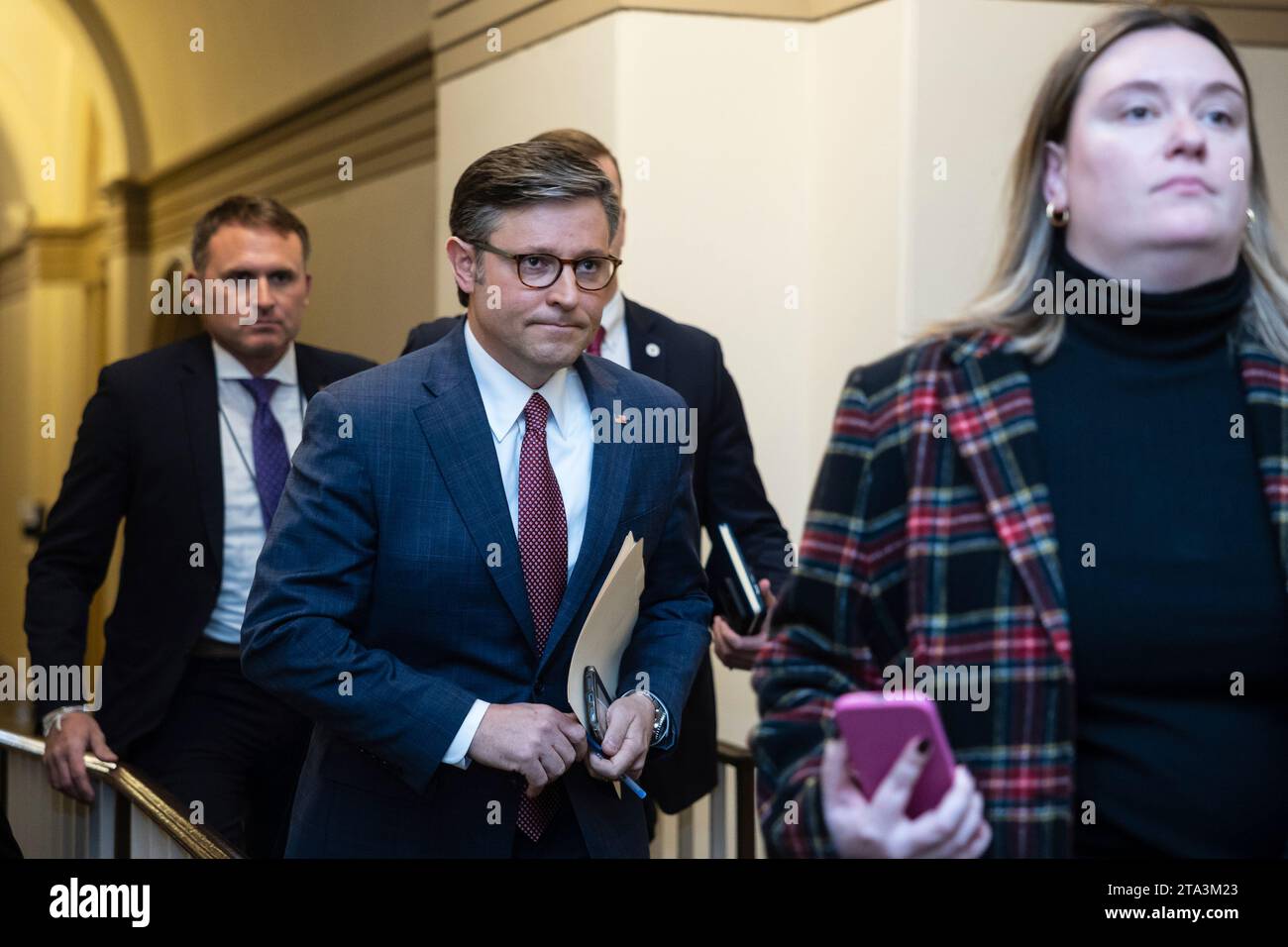 House Speaker Mike Johnson (R-La.), flanked by aides and his security ...