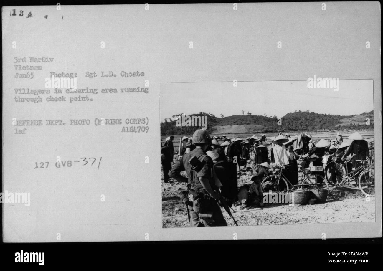 In June 1965, Vietnamese villagers are captured rushing through a ...
