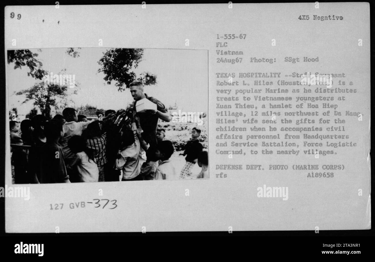 "Staff Sergeant Robert L. Hiles distributes treats to Vietnamese ...