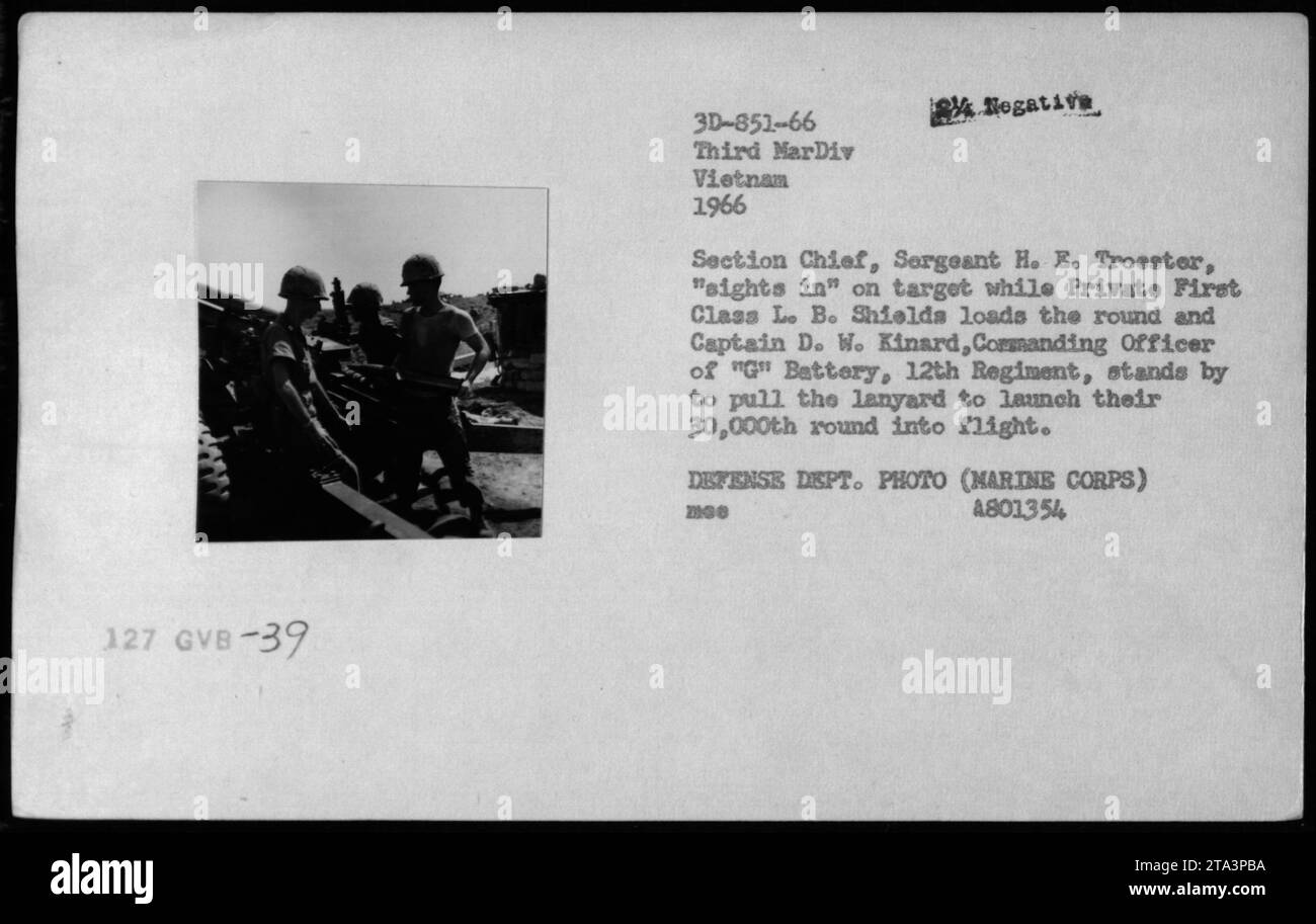 Marine Corps personnel prepared a cannon while PFC Le B. Shields loaded ...