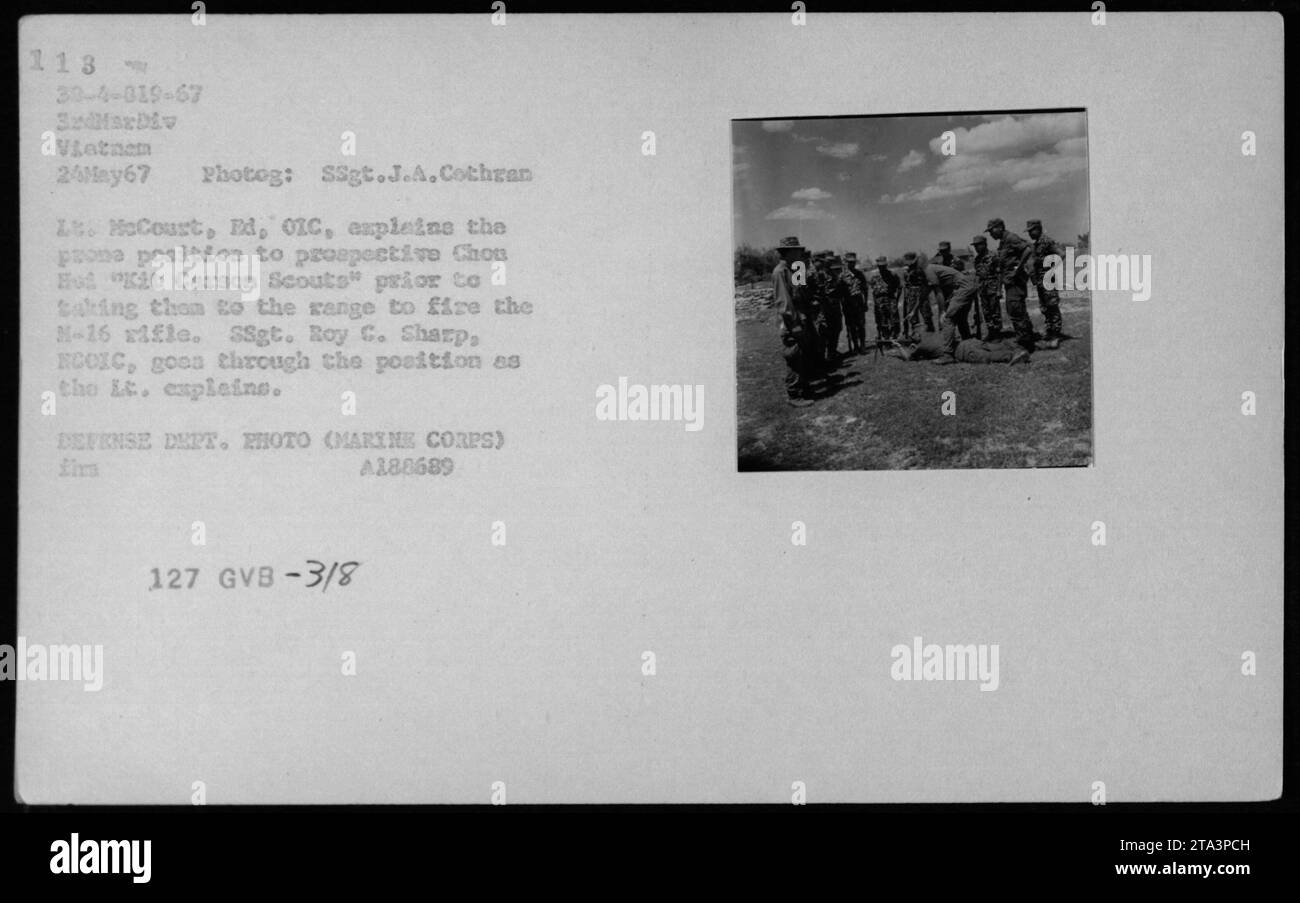 US soldier instructing Chou Hot "Kit Carson Scouts" on proper prone ...