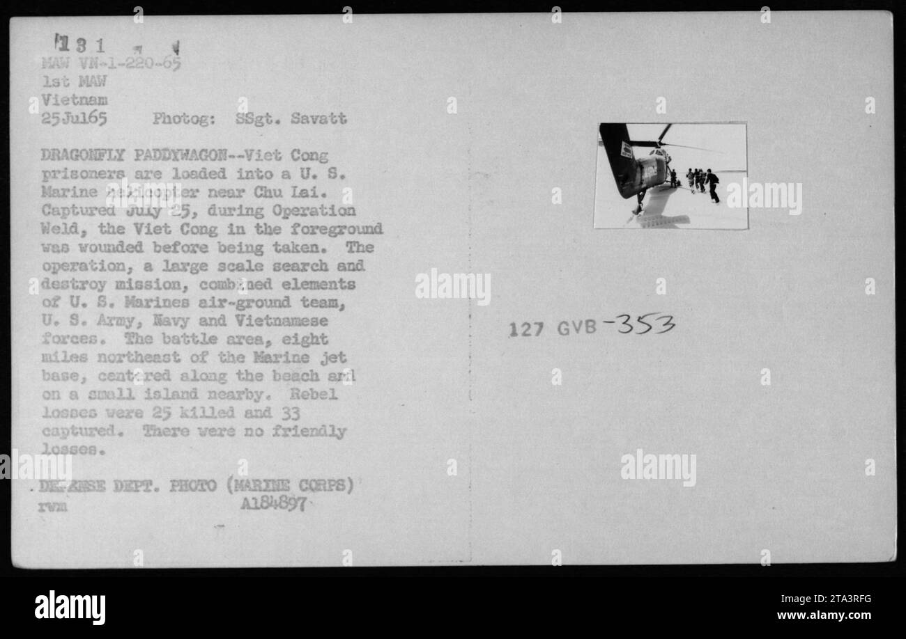 Viet Cong prisoners are being loaded into a U.S. Marine helicopter near ...