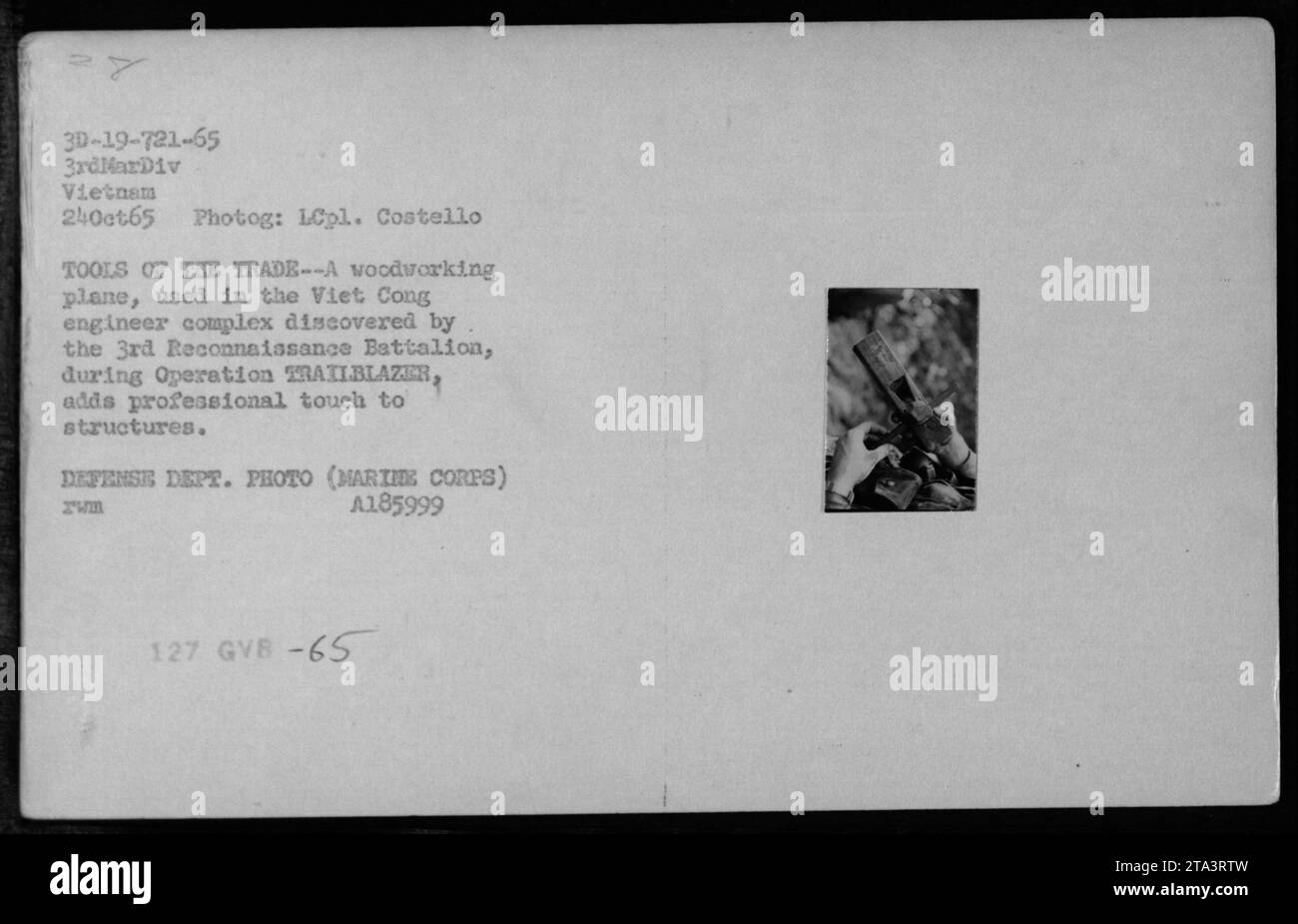 A person holds a woodworking plane captured from a Viet Cong engineer complex by the 3rd ...