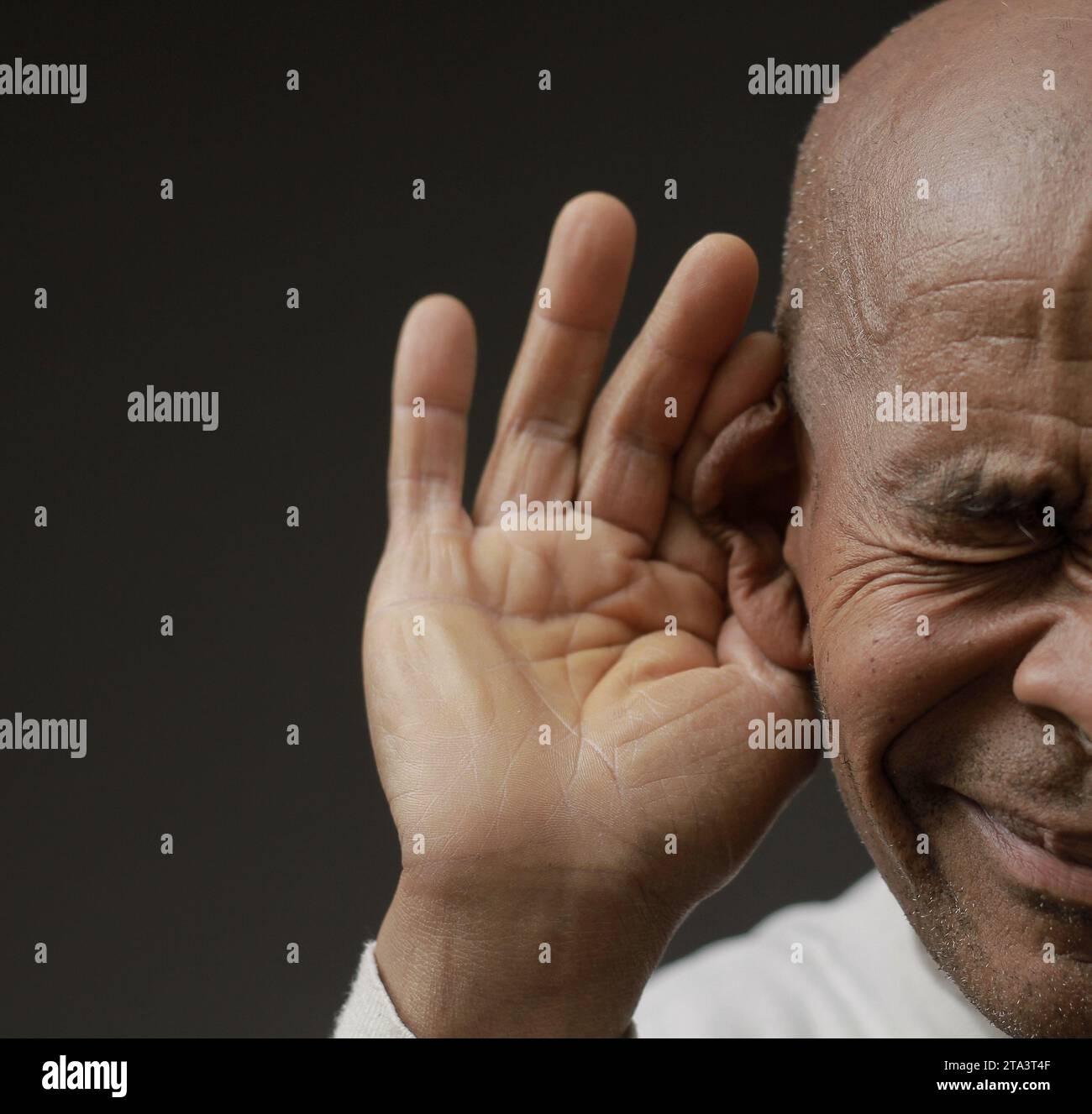 suffering from deafness and hearing loss on grey black background with ...