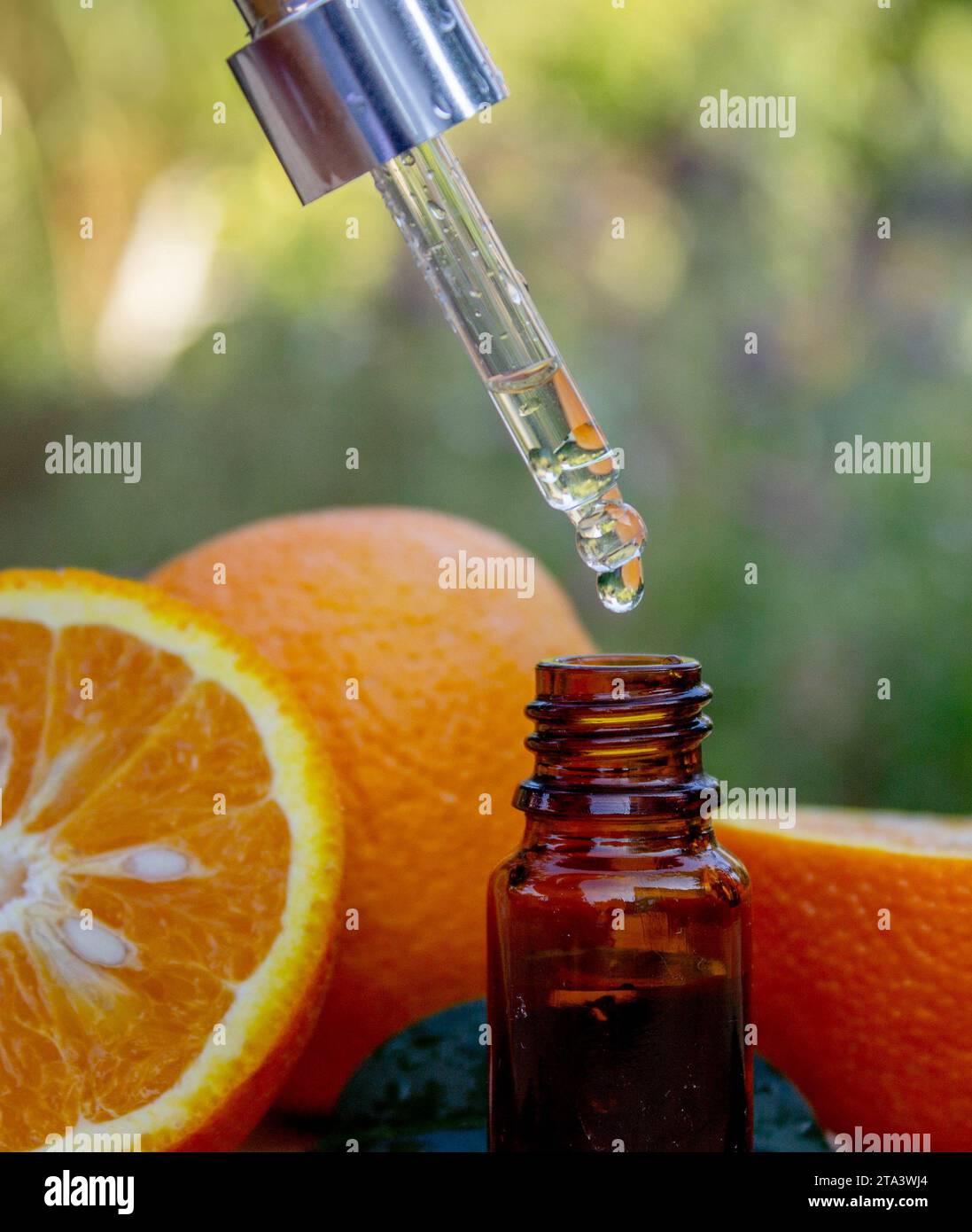 Essential extract of orange oil in a small bottle Stock Photo - Alamy