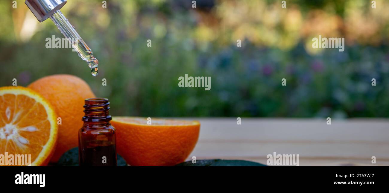 Essential extract of orange oil in a small bottle Stock Photo - Alamy