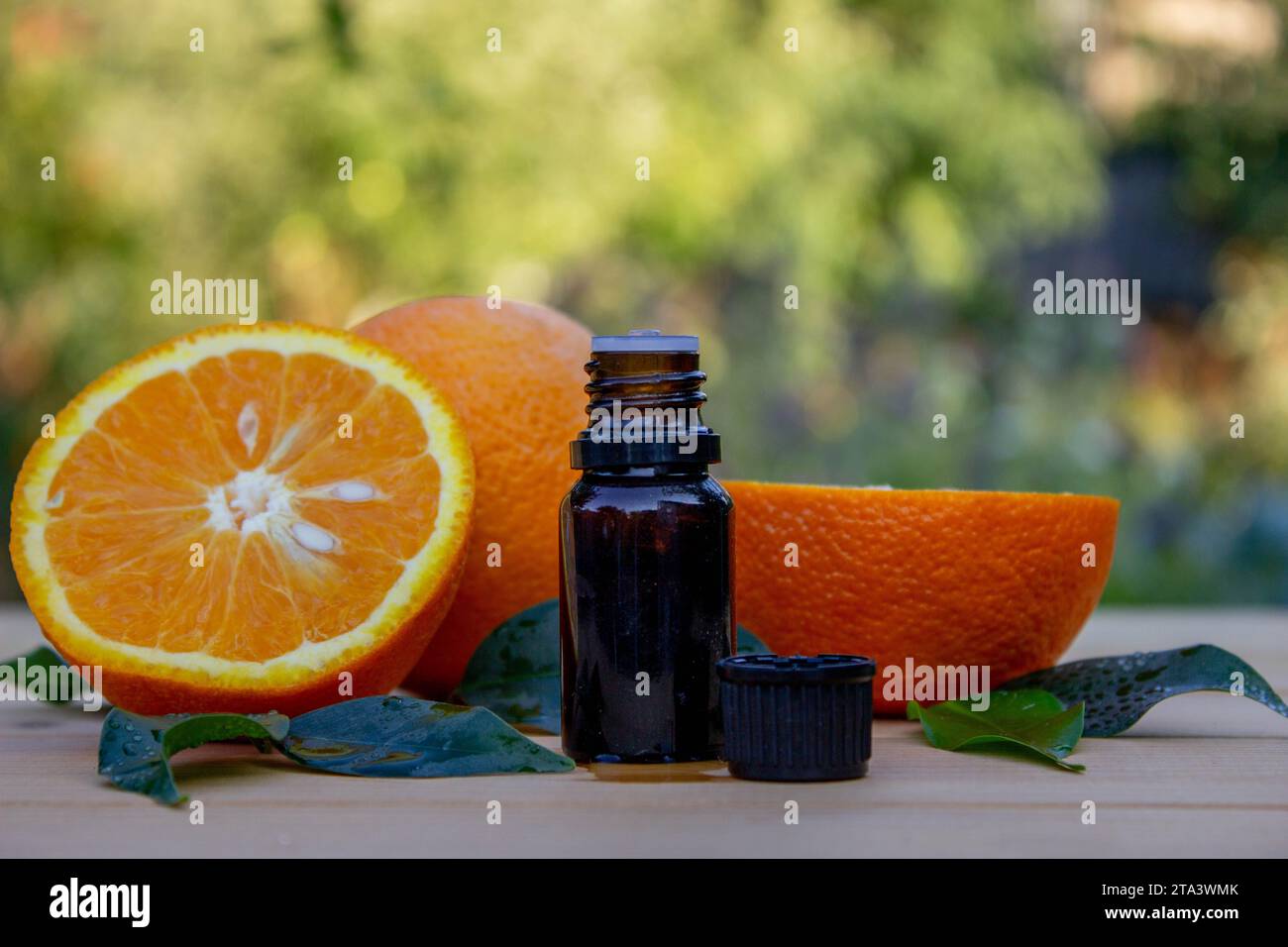 Essential extract of orange oil in a small bottle Stock Photo - Alamy