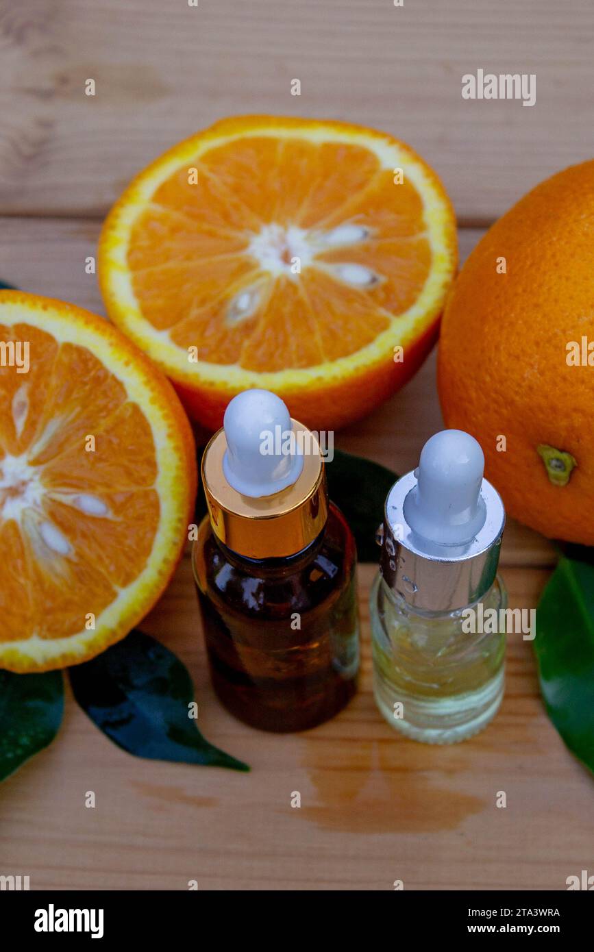 Essential extract of orange oil in a small bottle Stock Photo - Alamy