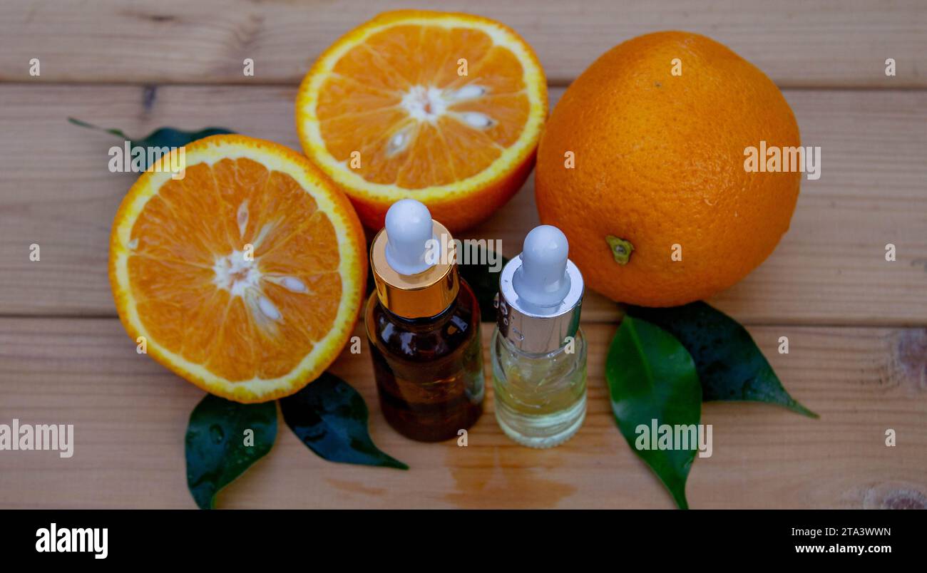 Essential extract of orange oil in a small bottle Stock Photo - Alamy