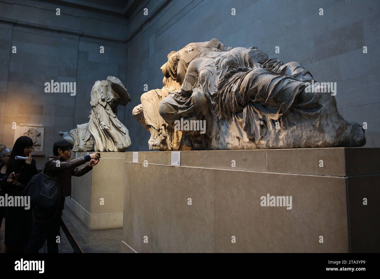 Visitors view Elgin marbles also known as the Parthenon marbles, at the British Museum, London ...