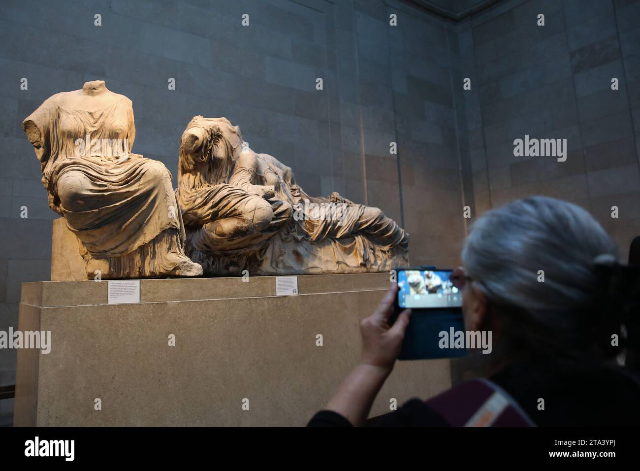 A visitor takes photograph of Elgin marbles also known as the Parthenon marbles, at the British ...