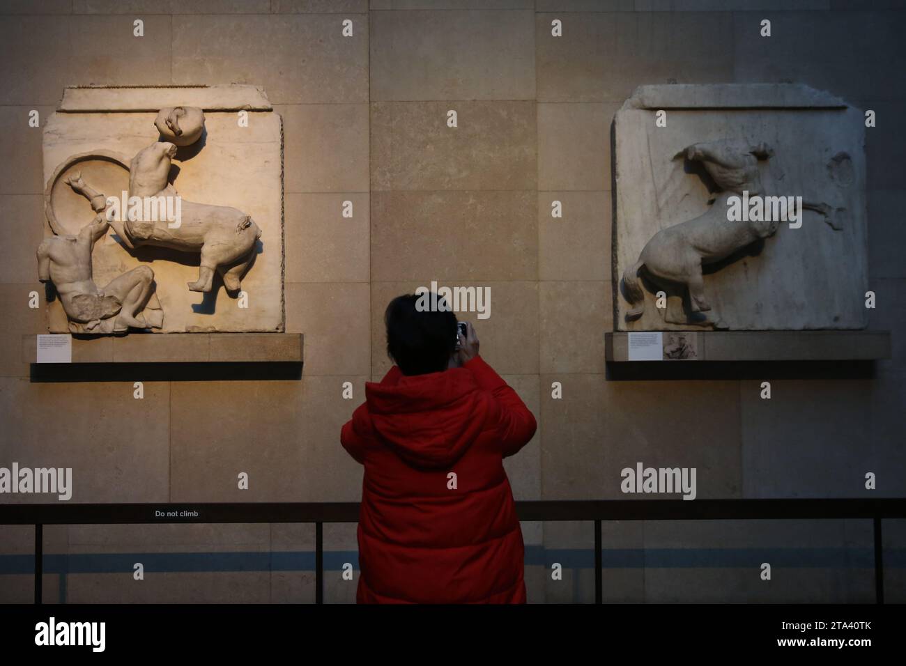 London, UK. 28th Nov, 2023. A visitor takes photograph of Elgin marbles ...
