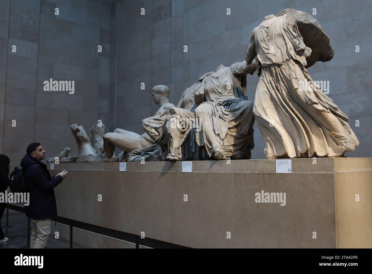 A visitor views Elgin marbles also known as the Parthenon marbles, at the British Museum, London ...