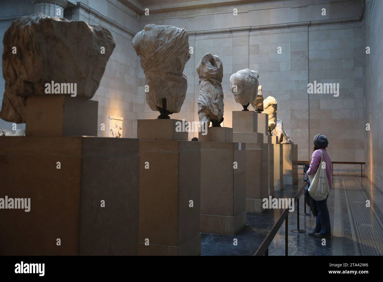 A visitor views Elgin marbles also known as the Parthenon marbles, at the British Museum, London ...