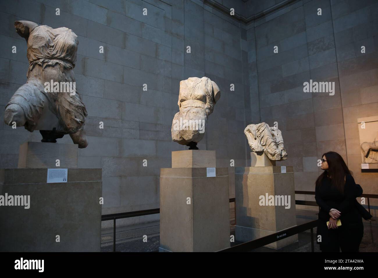 A visitor views Elgin marbles also known as the Parthenon marbles, at the British Museum, London ...