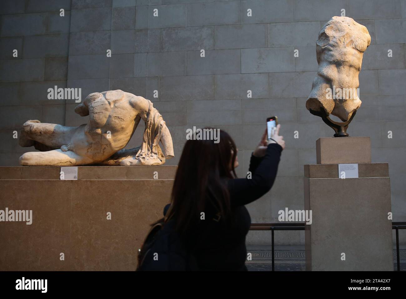 A visitor takes photograph of Elgin marbles also known as the Parthenon marbles, at the British ...