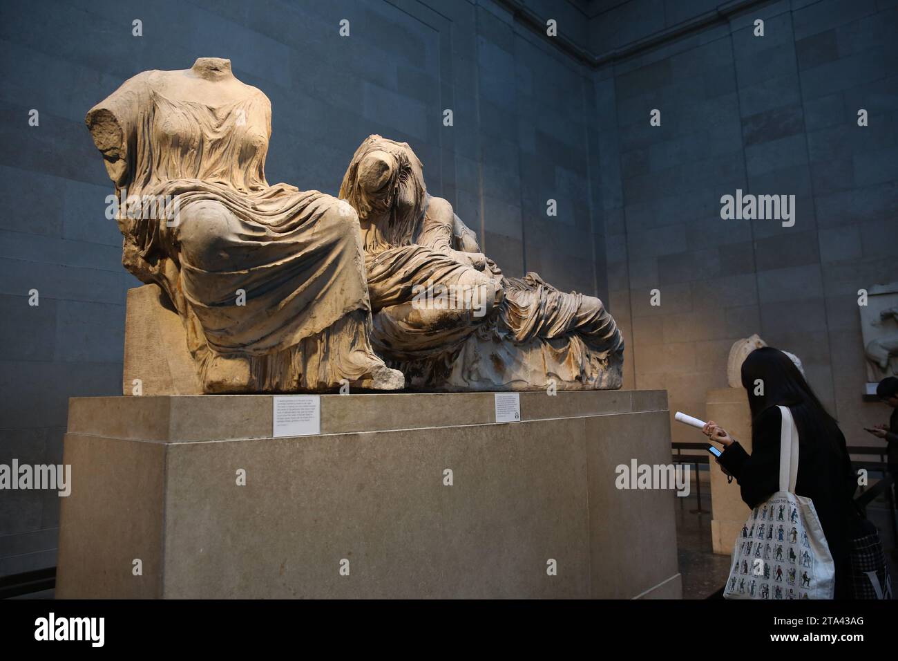 A visitor views Elgin marbles also known as the Parthenon marbles, at the British Museum, London ...