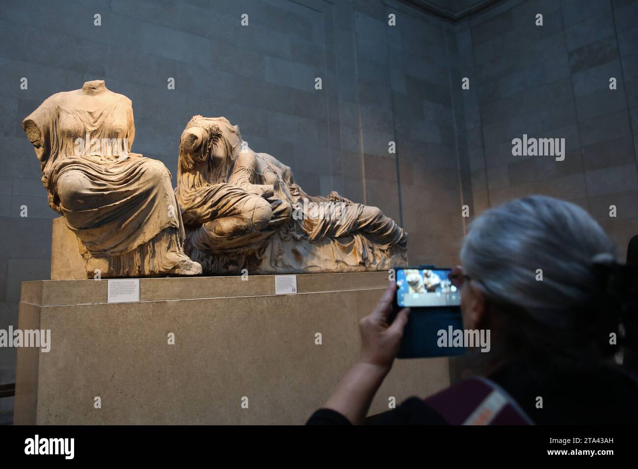 A visitor takes photograph of Elgin marbles also known as the Parthenon marbles, at the British ...