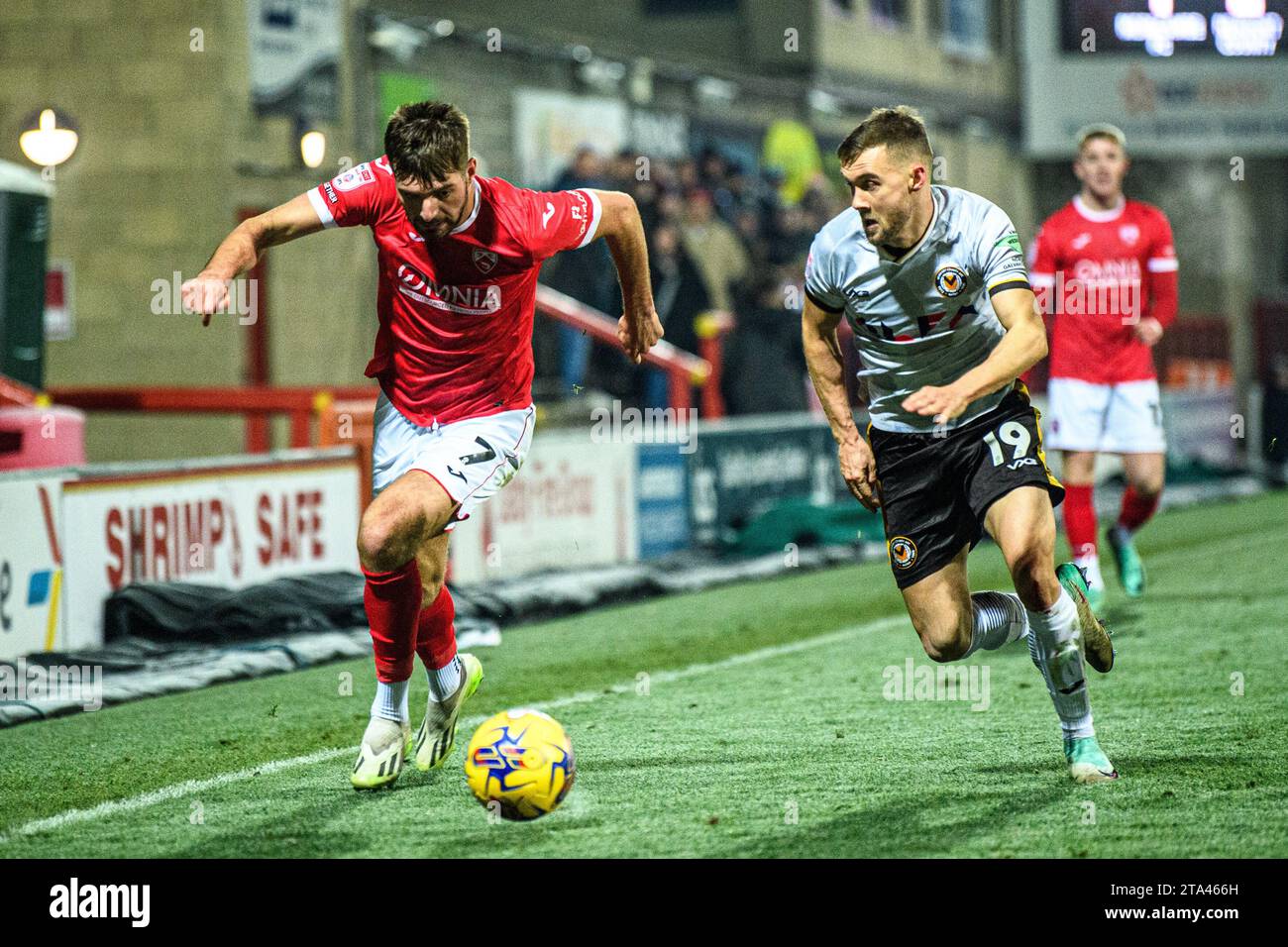 Morecambe's Tom Bloxham under pressure from Newport's Shane McLoughlin ...