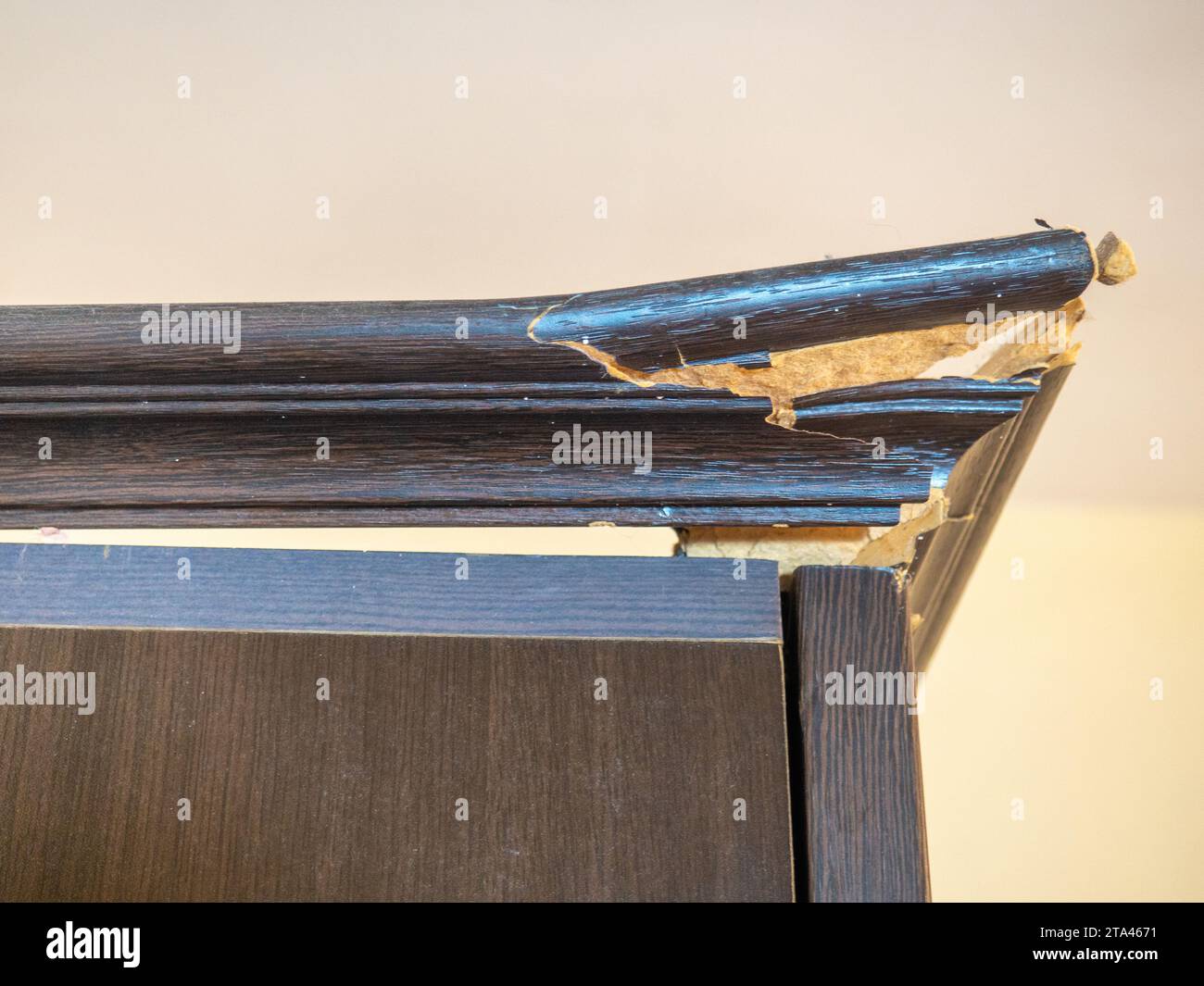 corner of the cabinet is broken. Crack in a wooden cabinet. Breakage ...