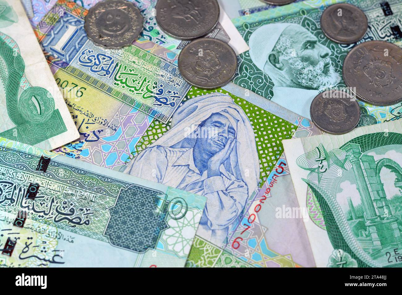 Background of old Libyan money banknote bills and coins of different ...