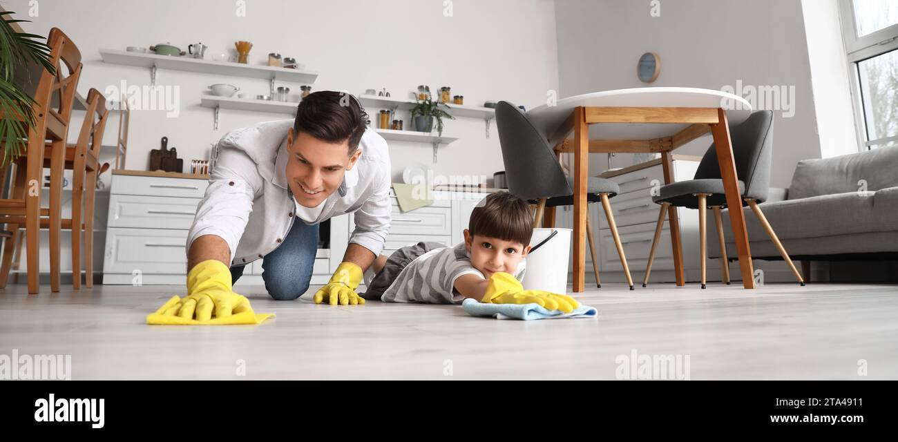 Father and son cleaning floor in kitchen Stock Photo - Alamy