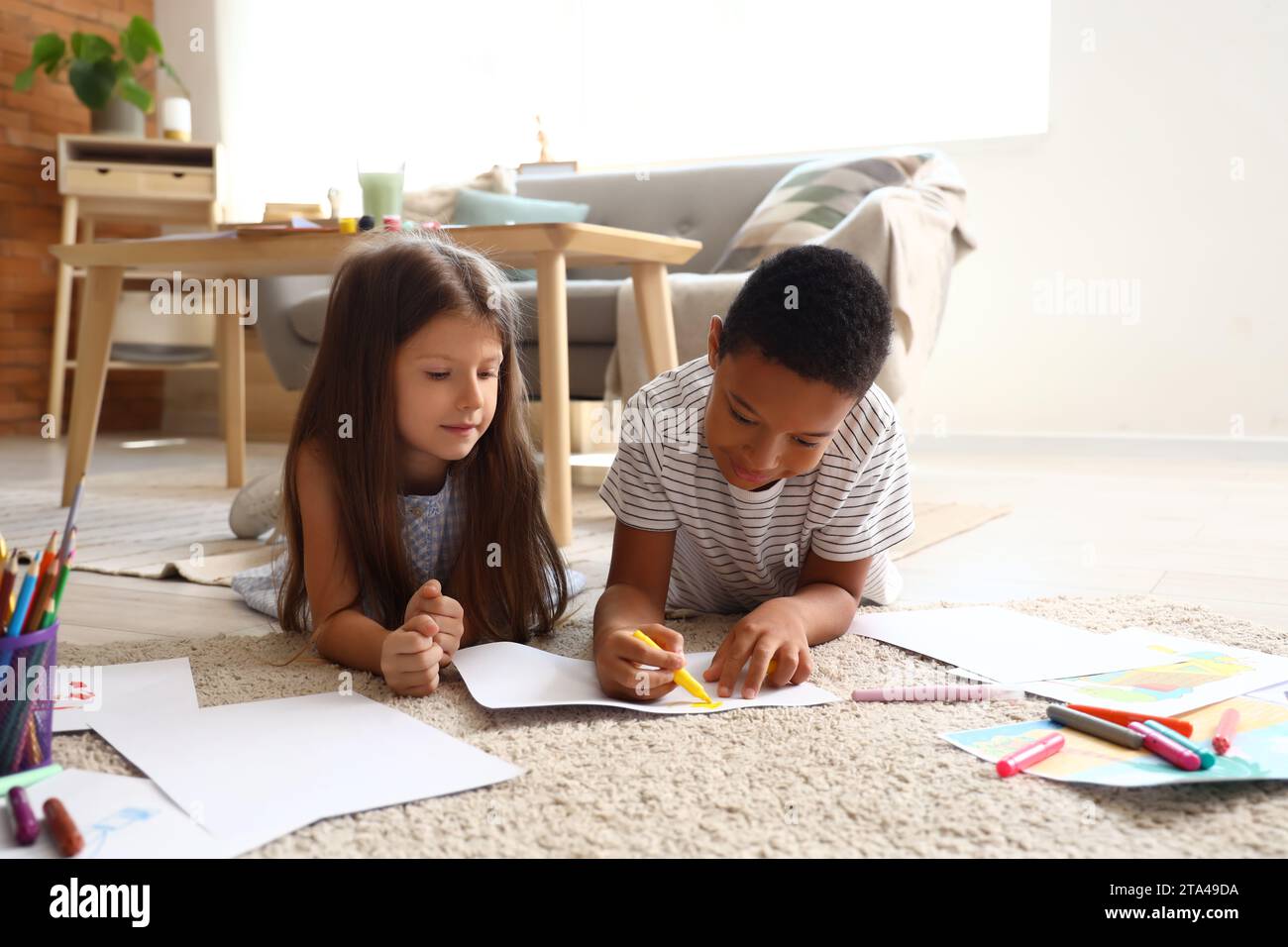 Cute little children drawing at home Stock Photo - Alamy