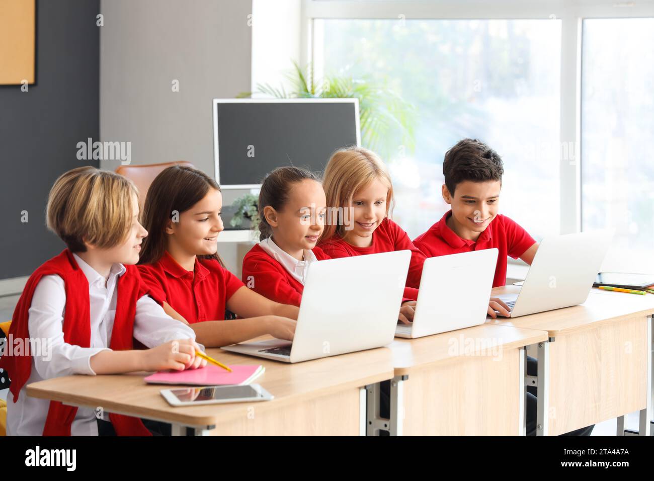 Little children studying with laptops at school computer lab Stock ...
