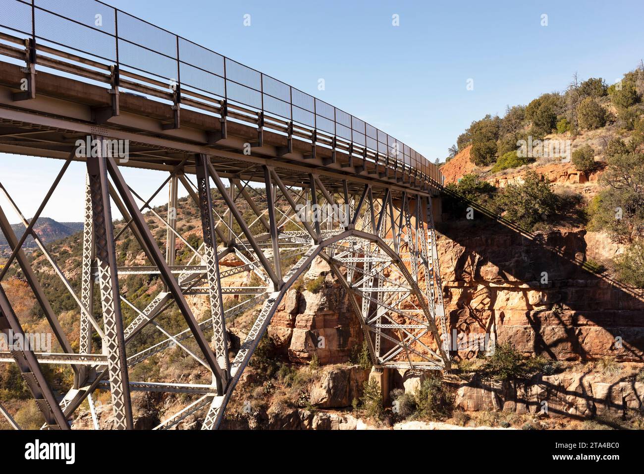 Metal Construction Of Bridge Supports Against Blue Sky And Rocks ...