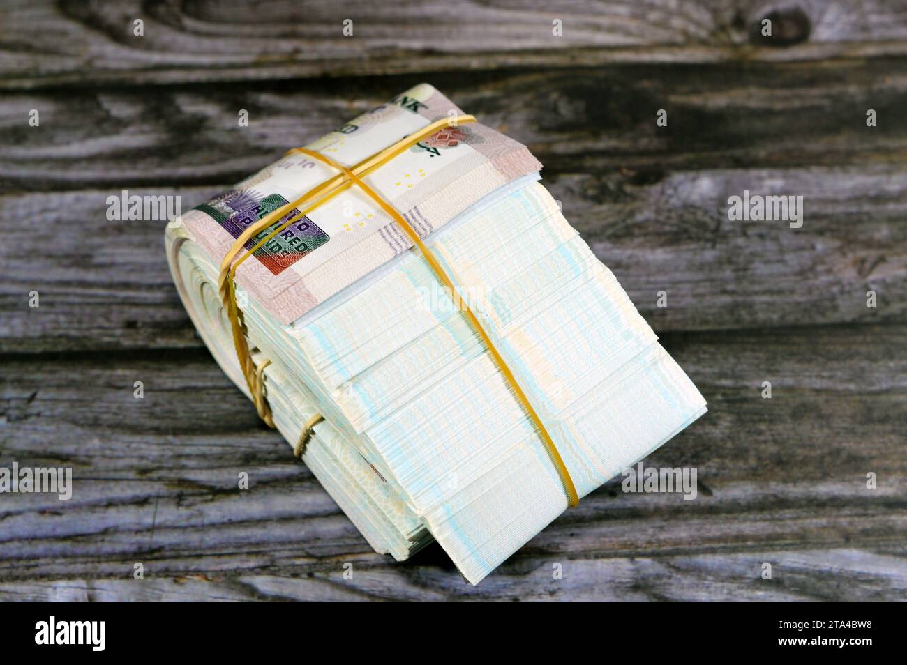Folded Egyptian money isolated on wooden background, 200 LE 100 EGP LE ... Folded Egyptian money isolated on wooden background, 200 LE 100 EGP LE ...