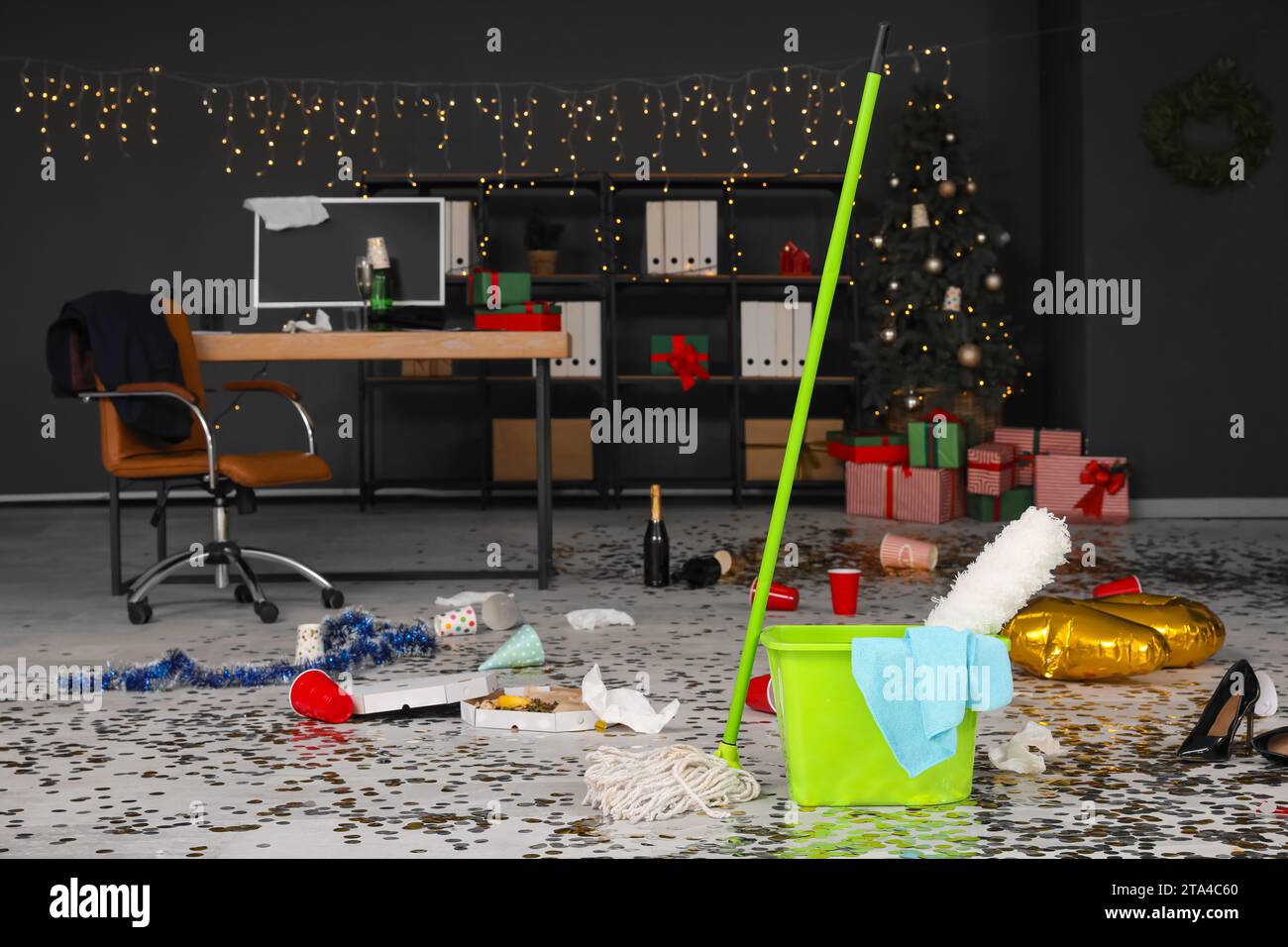 Interior of messy office with cleaning supplies after New Year party ...