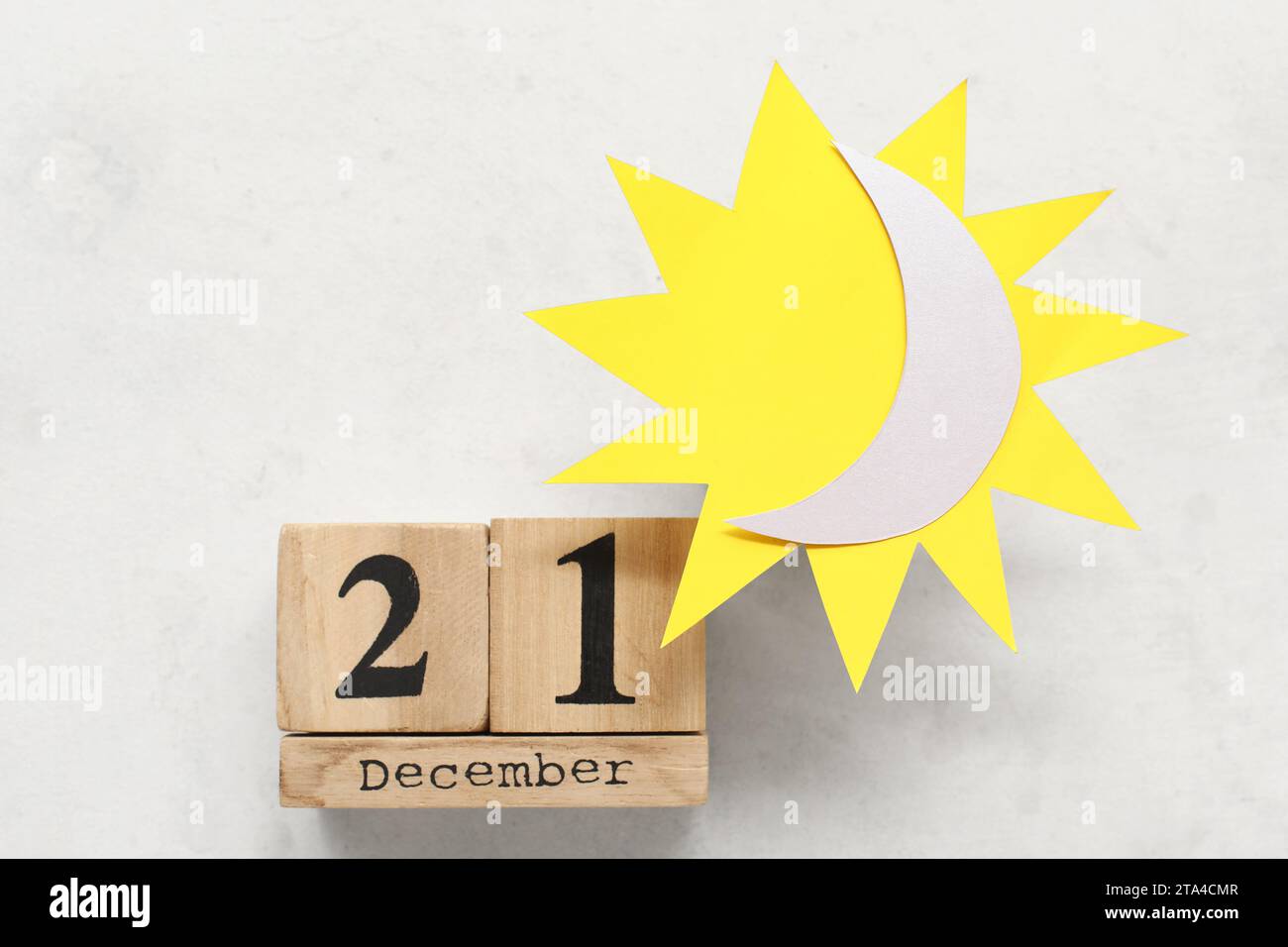 Cube calendar with date of winter solstice, paper sun and crescent on ...