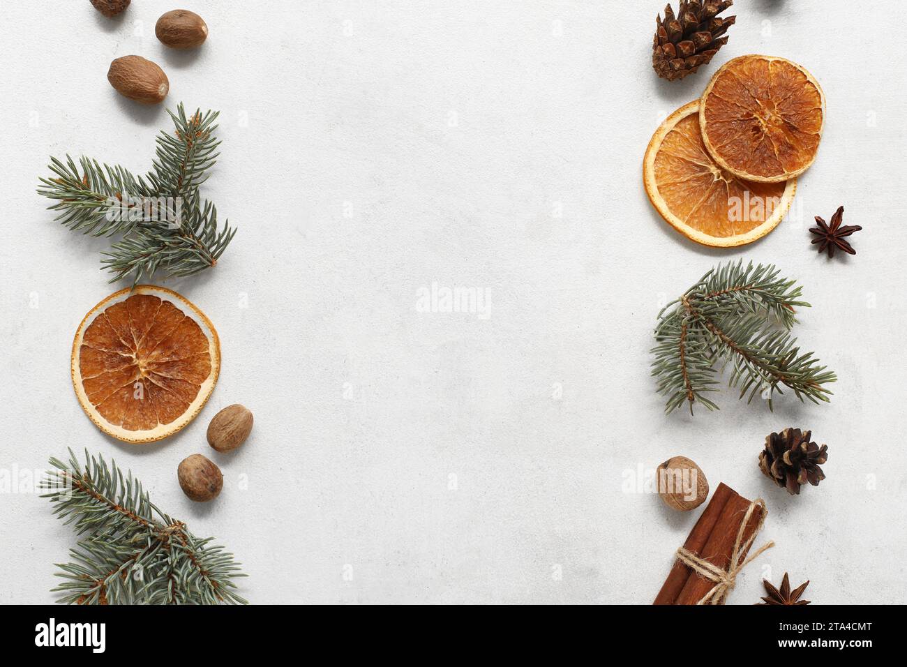 Frame made of fir branches with dried oranges and nuts on white ...