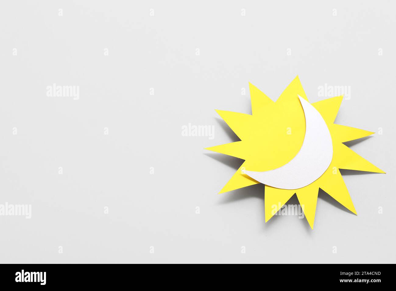 Paper sun with crescent on light background. Winter solstice concept ...
