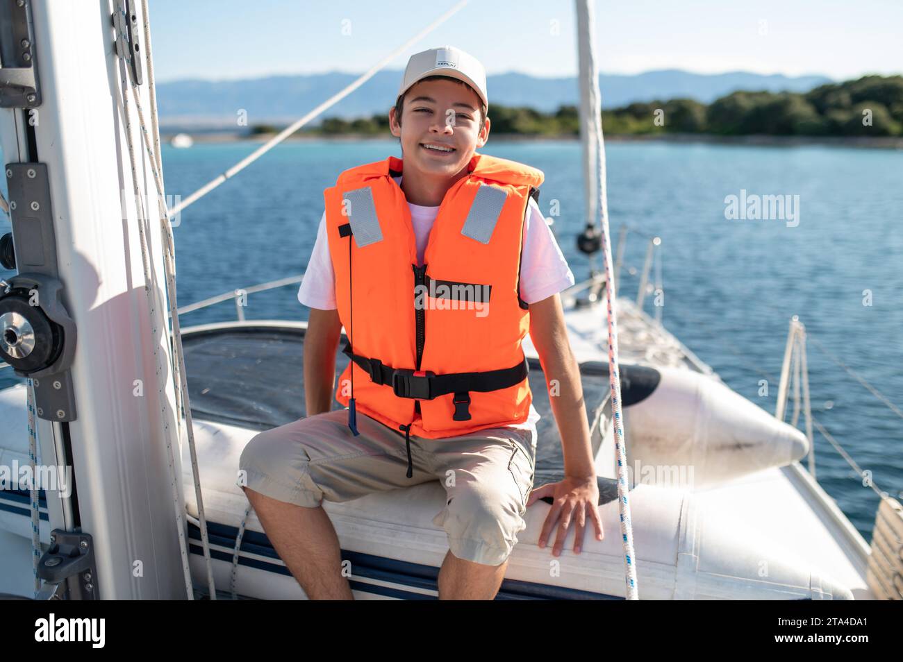 Smiling boy in a life-jacket on the boat Stock Photo - Alamy