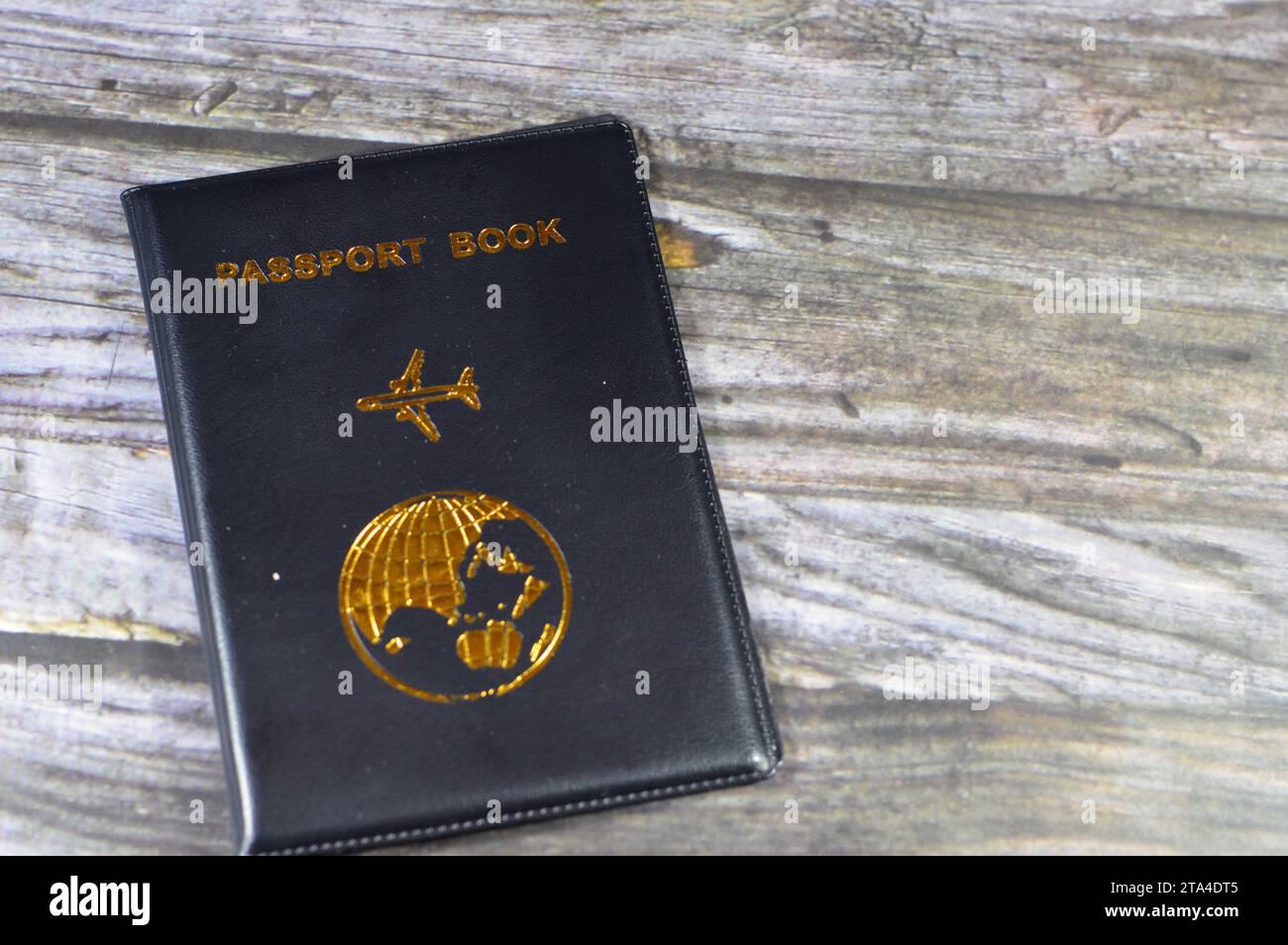 Black passport book with a plane and the globe earth on its cover ...