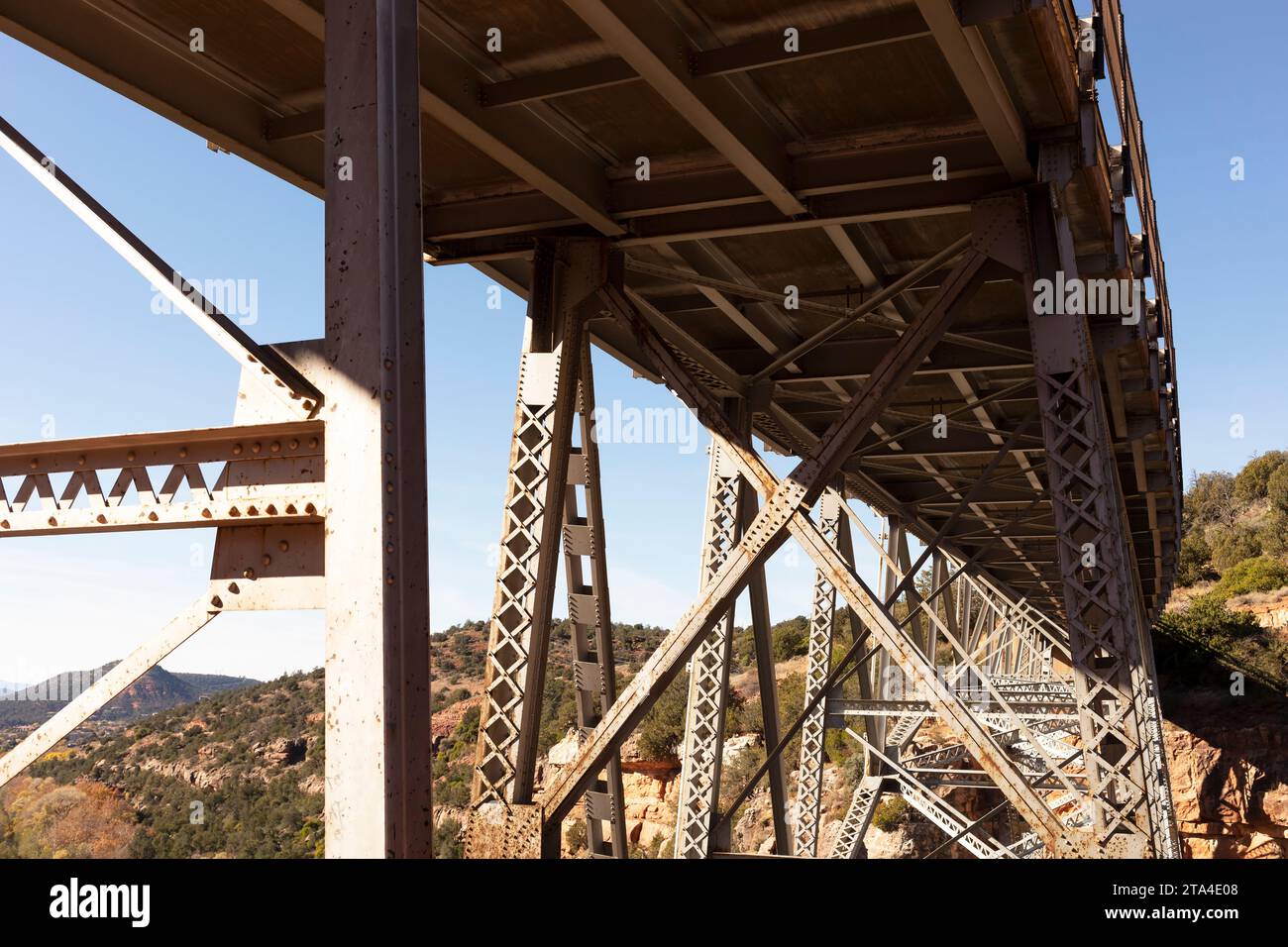 View Beneath Metal Construction Of Bridge Supports Against Blue Sky And ...