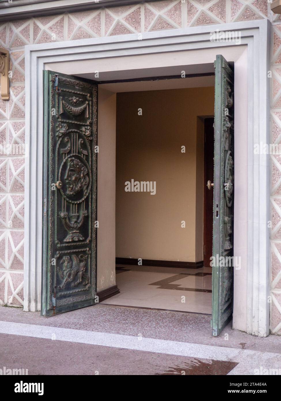 Wooden heavy doors to an old theater. Entrance to a pompous building ...