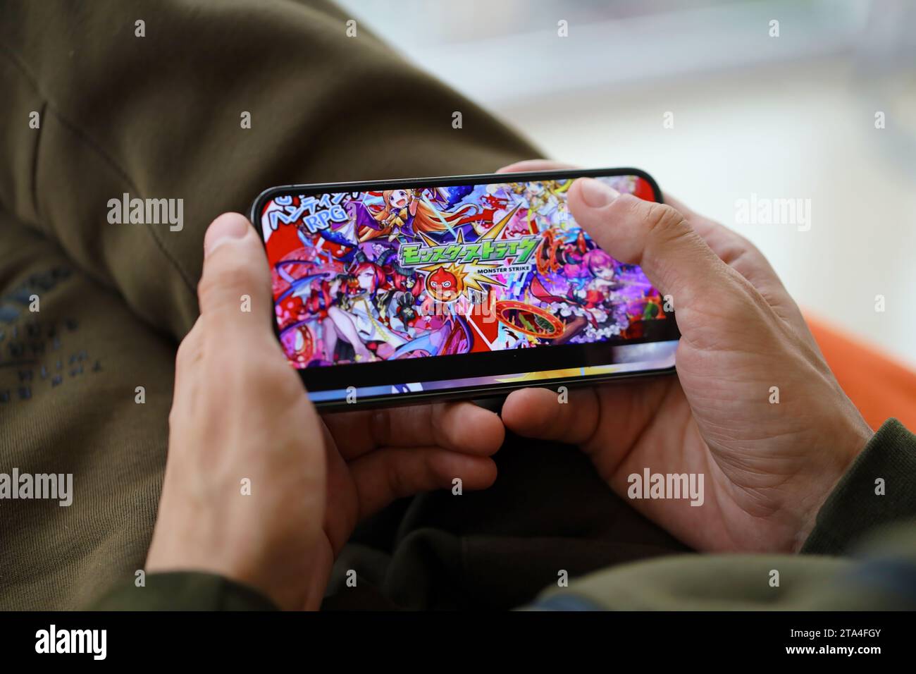 Monster Strike mobile iOS game on iPhone 15 smartphone screen in male ...