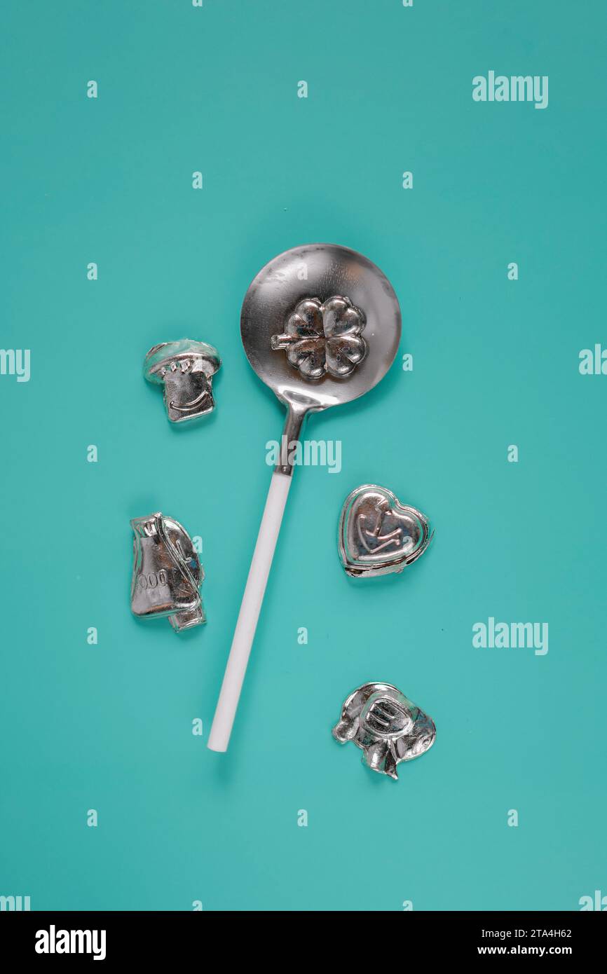 lead pouring set for New Years party.Tin spoon and tin figurines ...