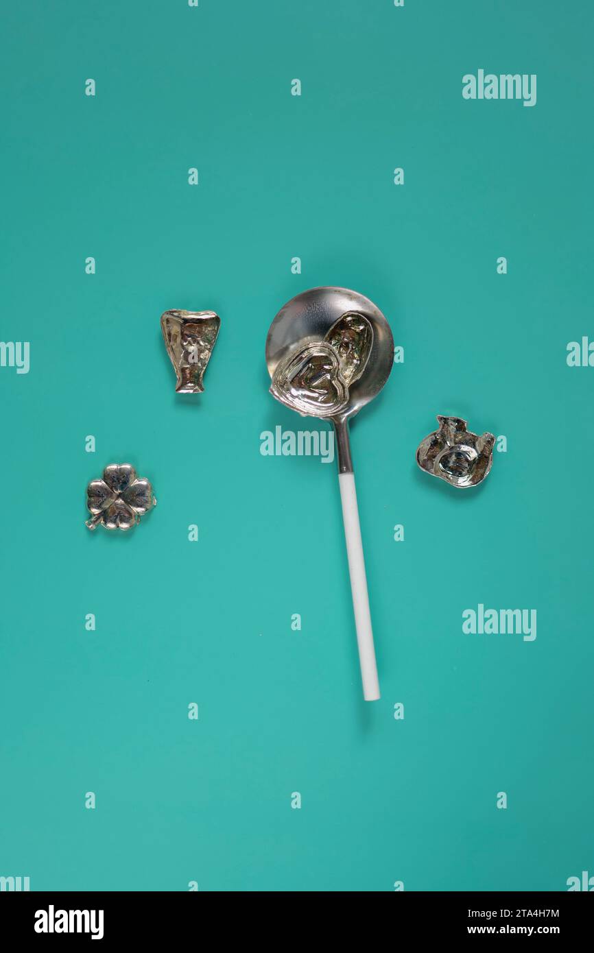 Fun tin casting set for New Years party.Tin spoon and tin figurines on ...