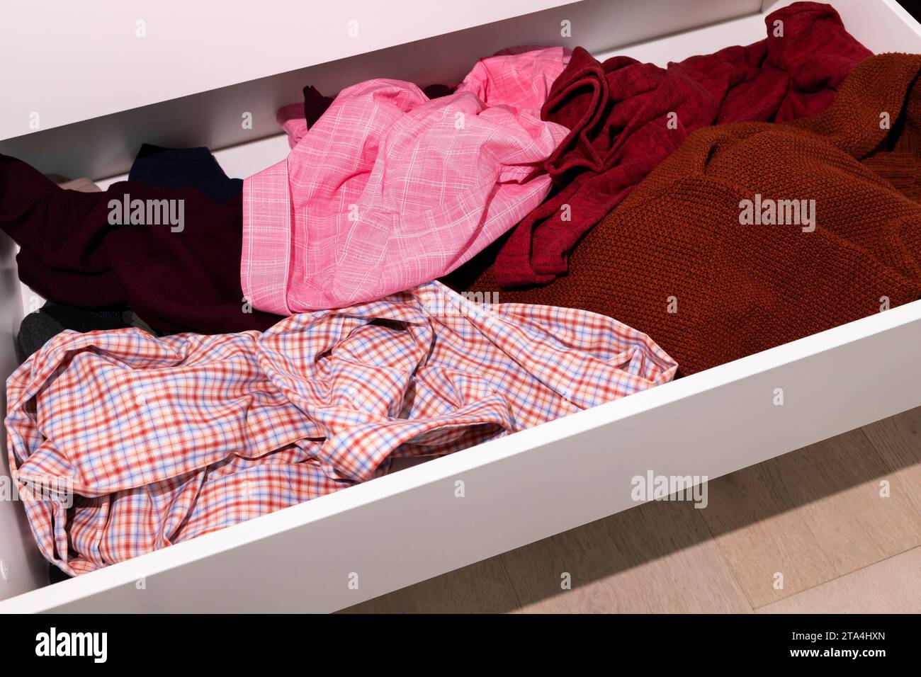 Messy Drawer With Dangling Unfolded Man's Clothes, Scattered Things ... Messy Drawer With Dangling Unfolded Man's Clothes, Scattered Things ...