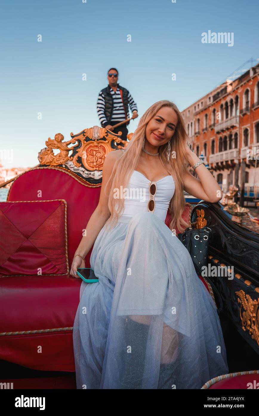 Romantic Couple Enjoying Gondola Ride Through Iconic Canals Of Venice