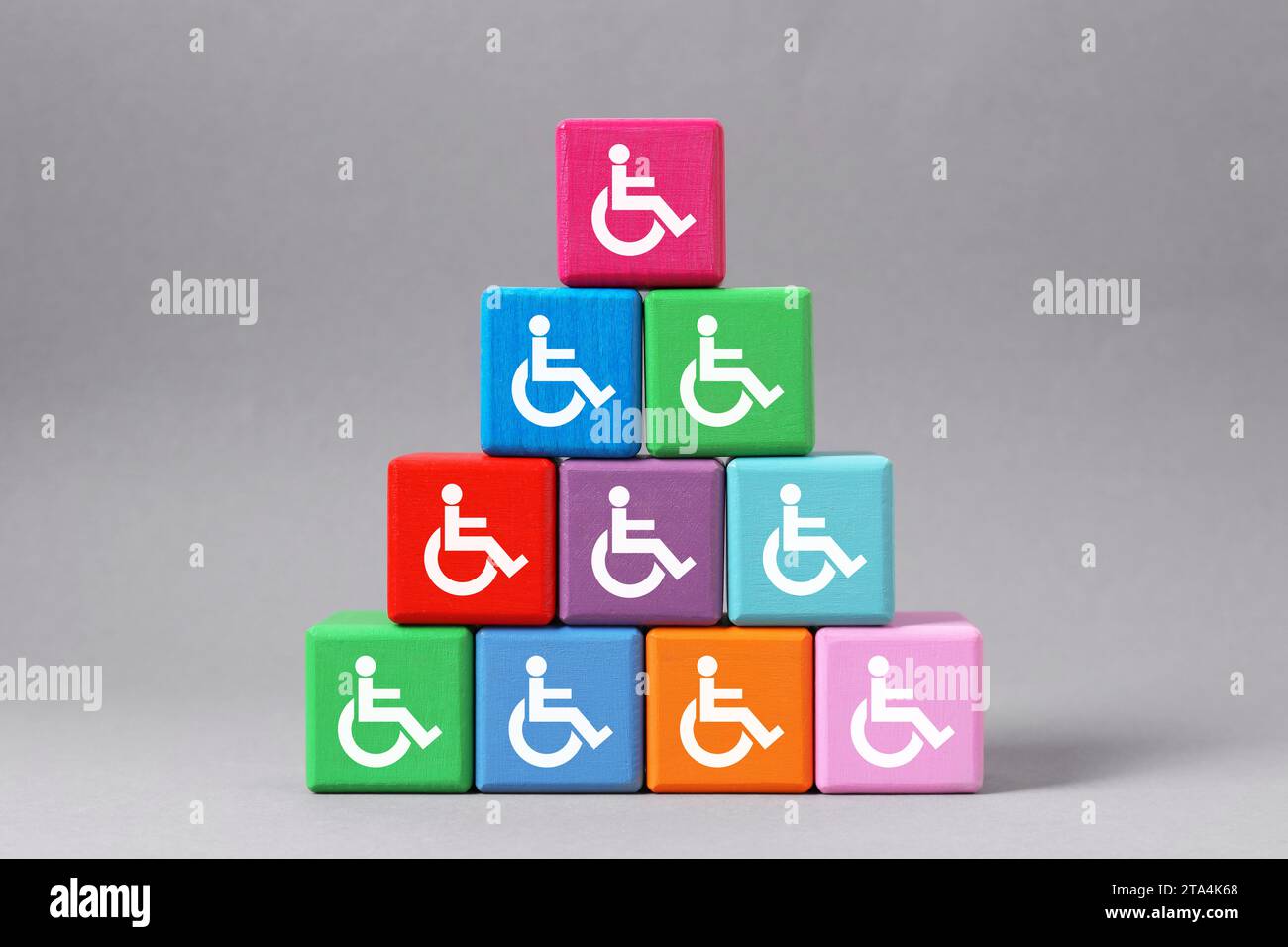 Inclusion concept. Pyramid of colorful cubes with international symbols ...