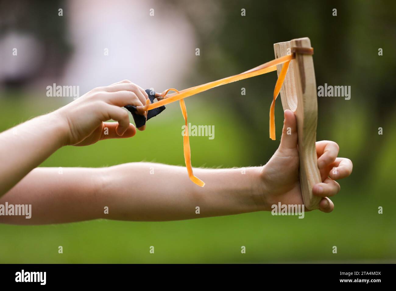 Little girl playing with slingshot outdoors, closeup Stock Photo - Alamy