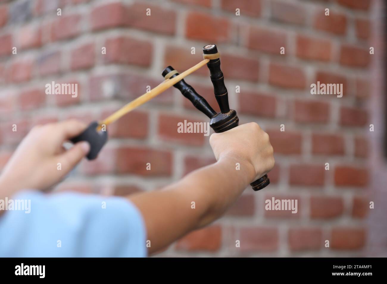 Little boy playing with slingshot outdoors, closeup Stock Photo - Alamy
