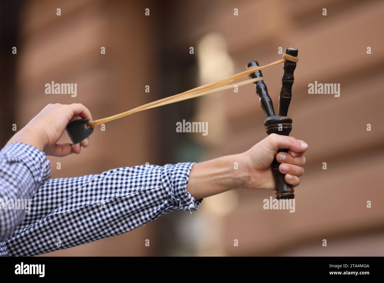 Little boy playing with slingshot outdoors, closeup Stock Photo - Alamy