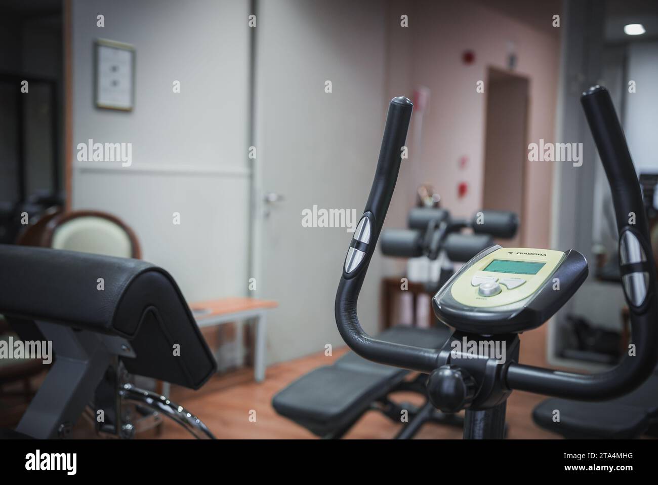 Modern home gym with rowing machine equipment in spacious room with ...